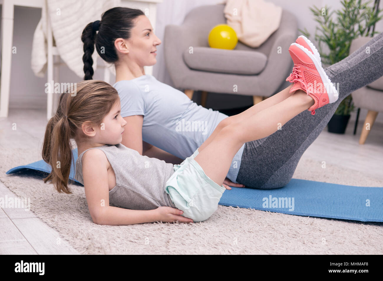 Merry mother training with her girl Stock Photo - Alamy