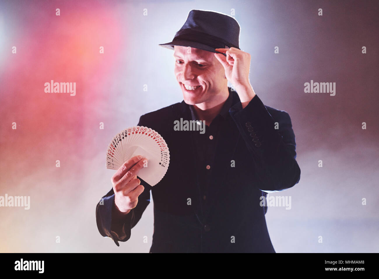 Magician showing trick with playing cards. Magic or dexterity, circus ...
