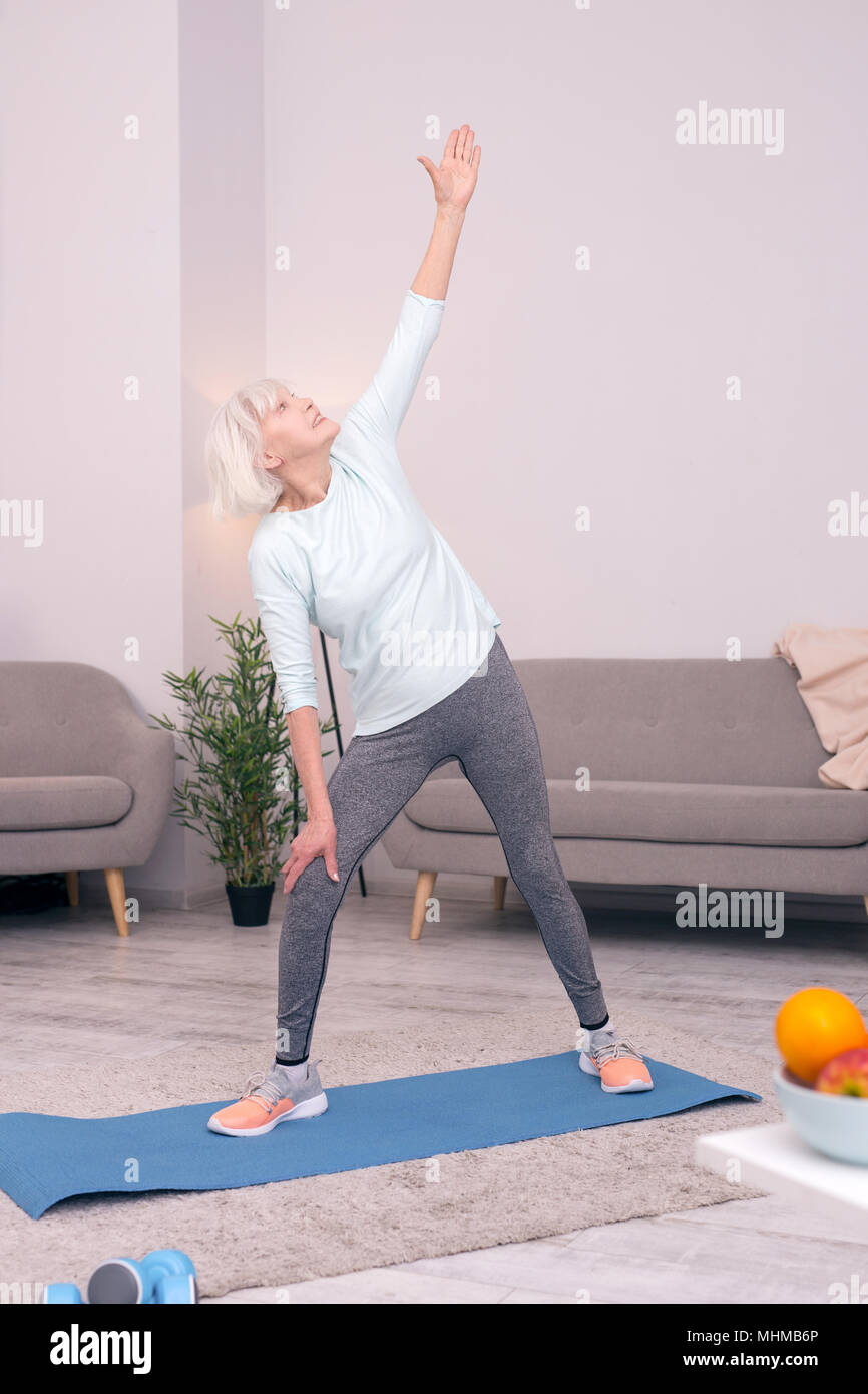 Upbeat senior woman standing in gate pose Stock Photo - Alamy