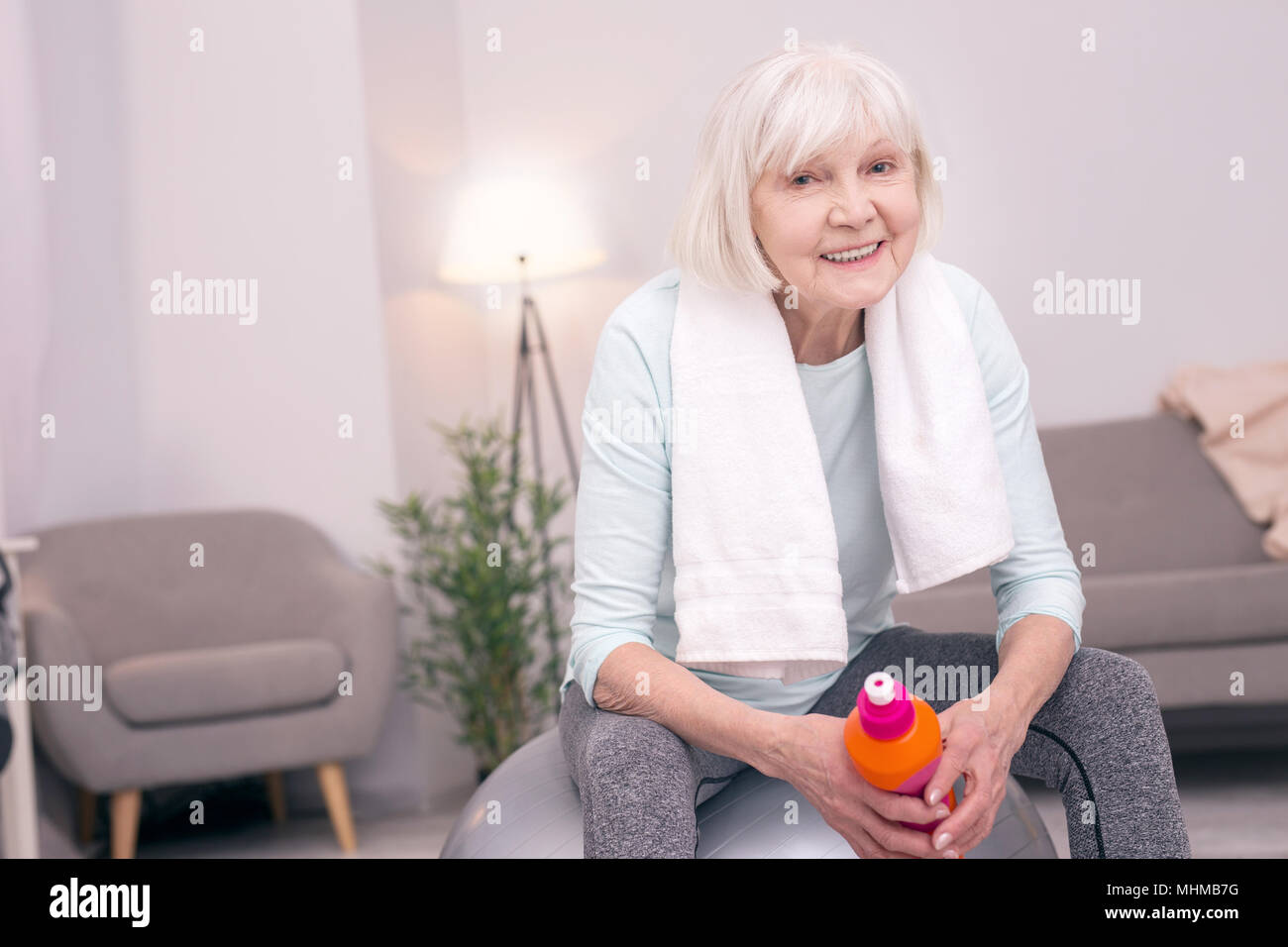 Beautiful elderly woman having rest after exercising Stock Photo - Alamy