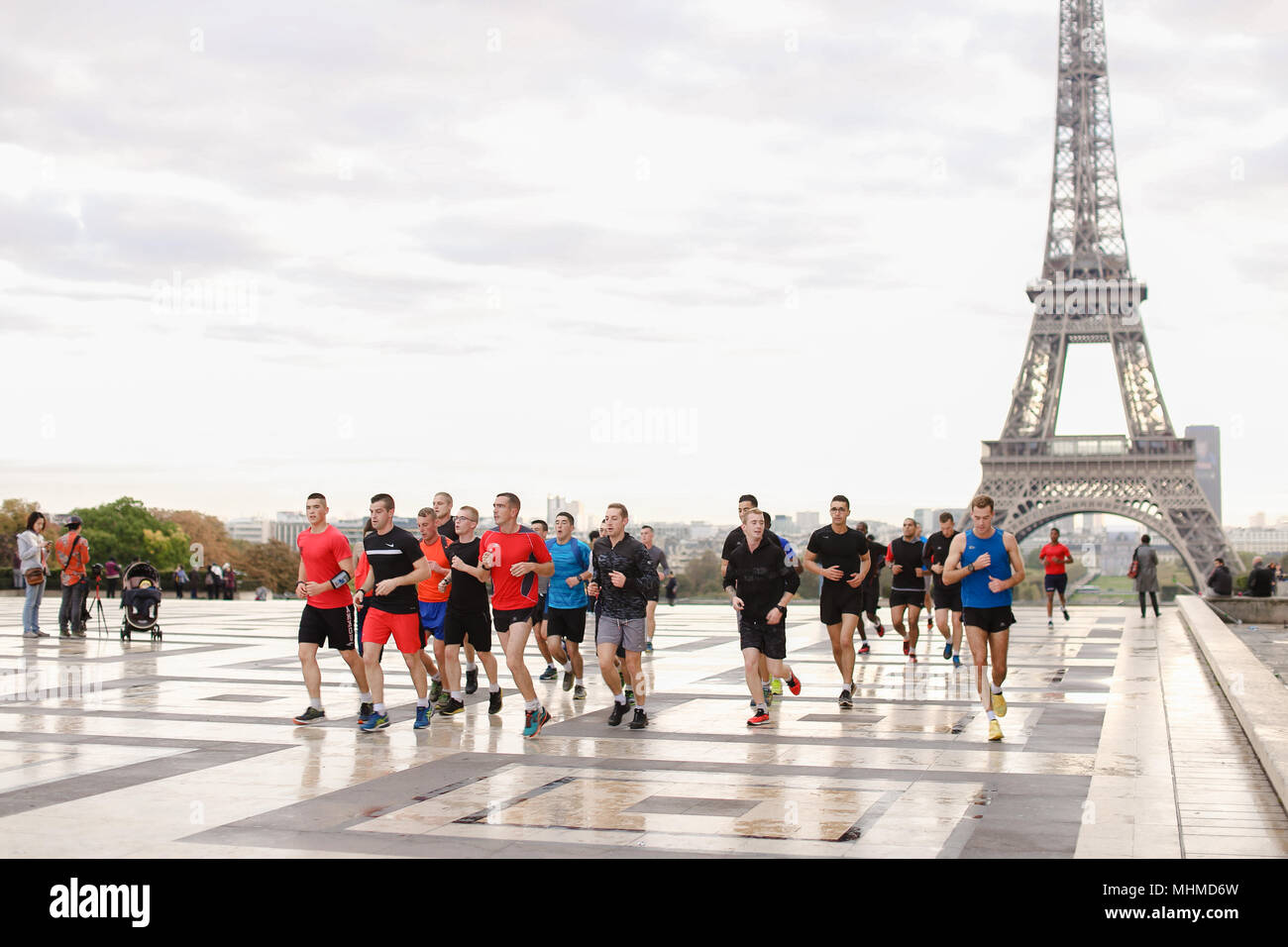 European team of runners running in Eiffel Tower background on ...