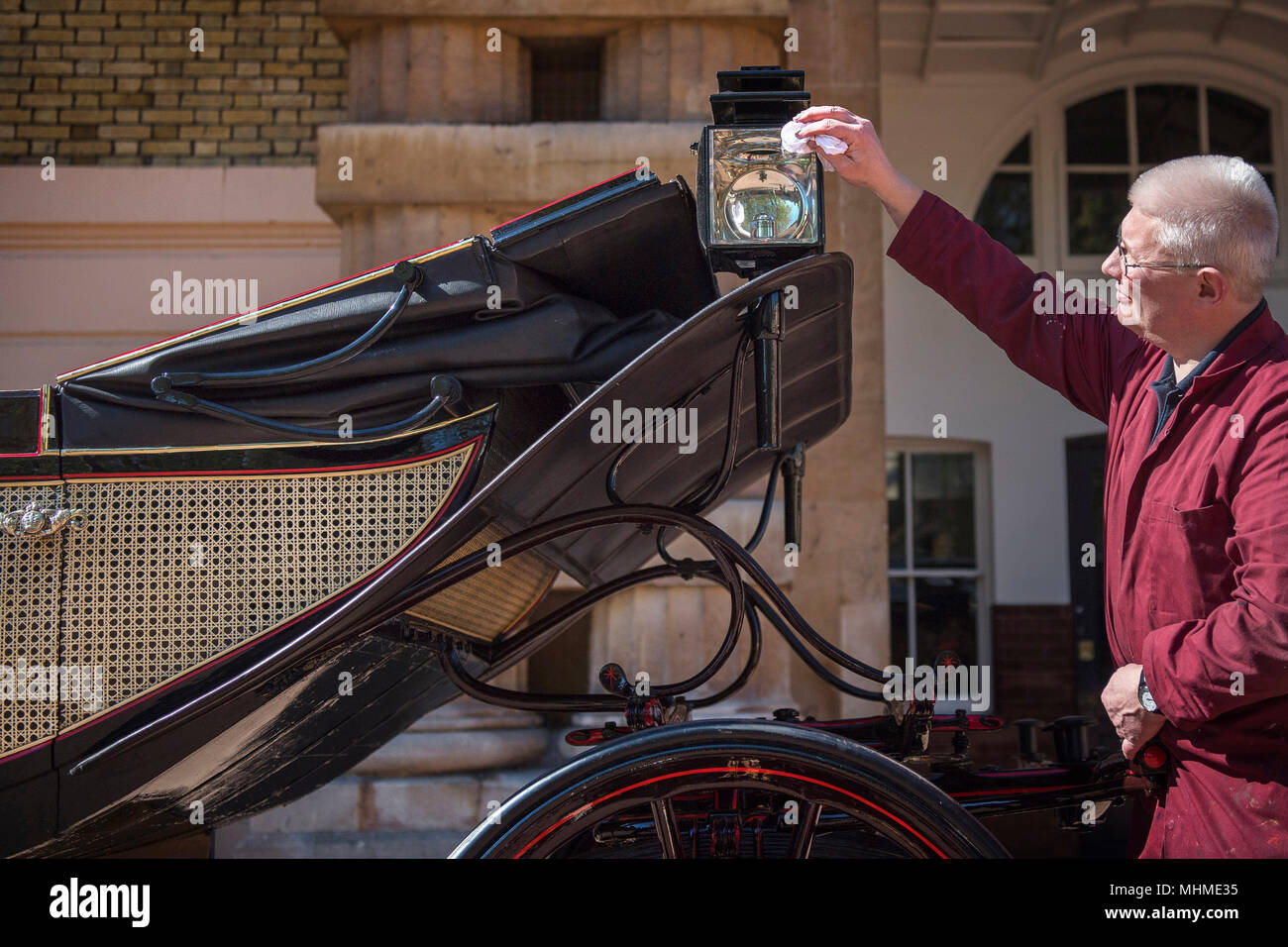 Martin Oates, Senior Carriage Restorer, polishes the Ascot Landau ...