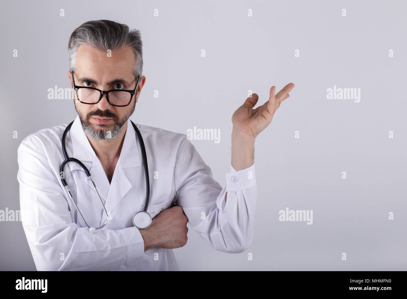 Middle age doctor wearing eyeglasses , pointing or holding something ...