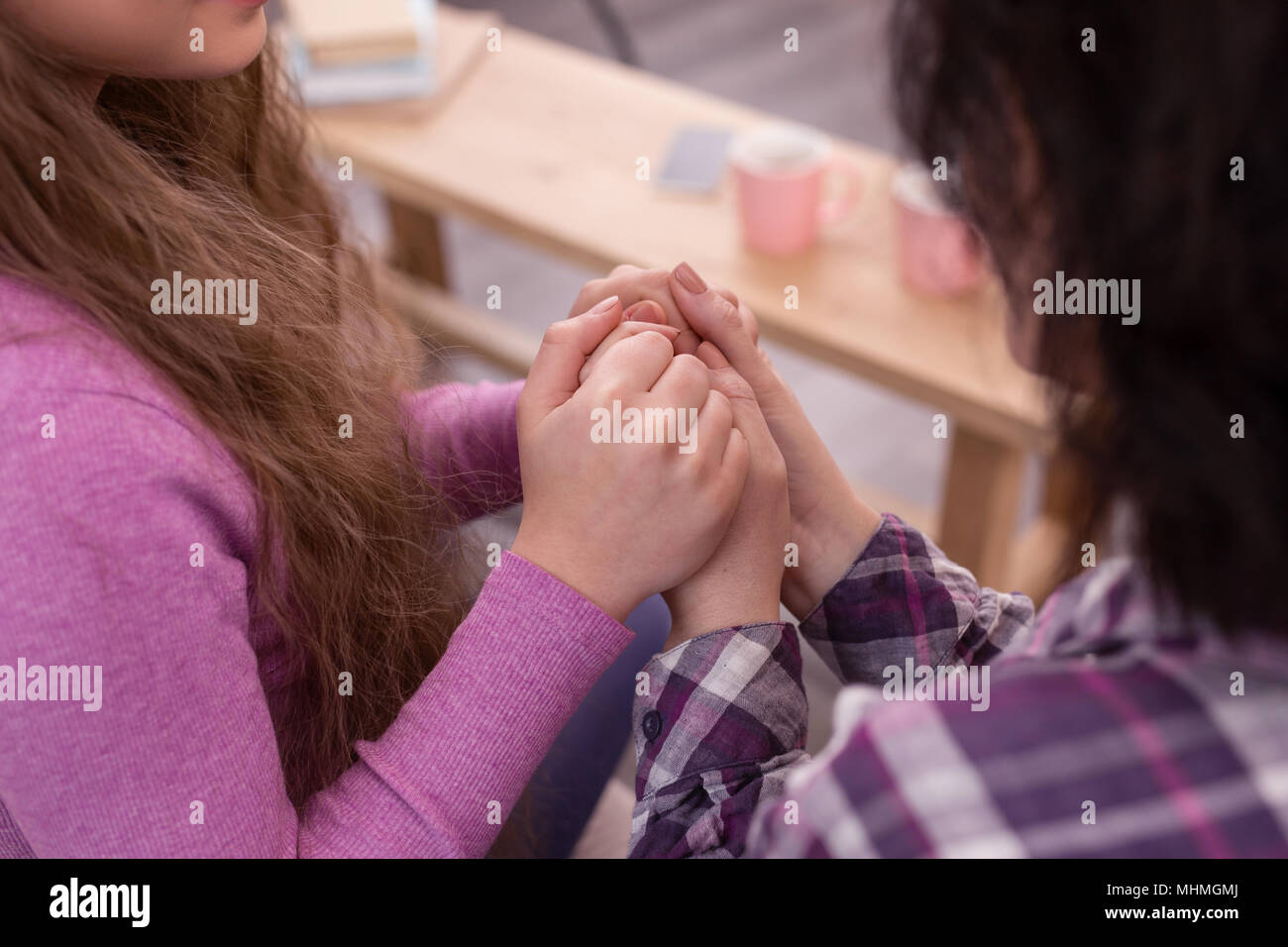 Tender female hands holding together Stock Photo - Alamy