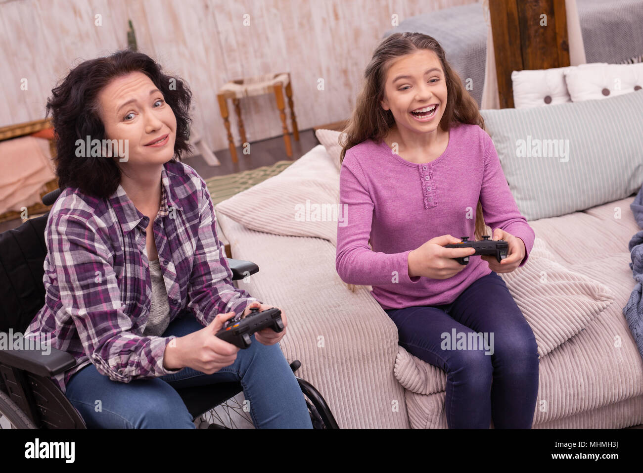 Happy incapacitated woman and girl playing games Stock Photo - Alamy