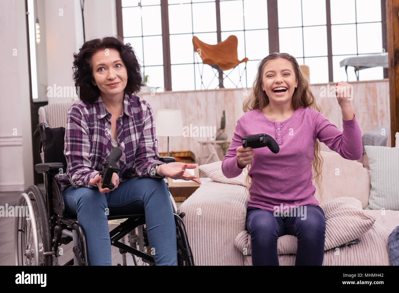 Merry incapacitated woman and girl having fun Stock Photo - Alamy