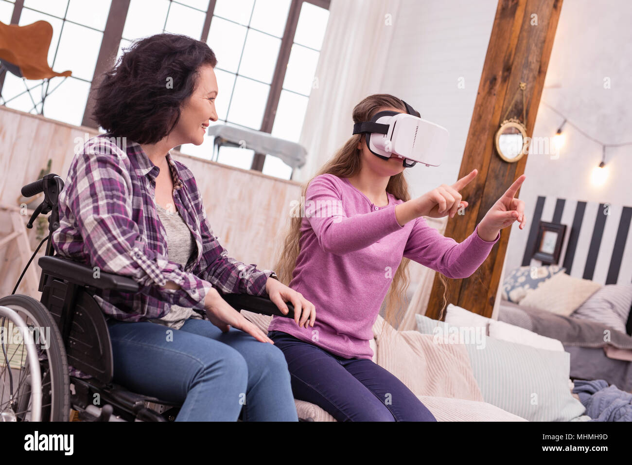 Happy disabled woman and girl experiencing VR Stock Photo - Alamy