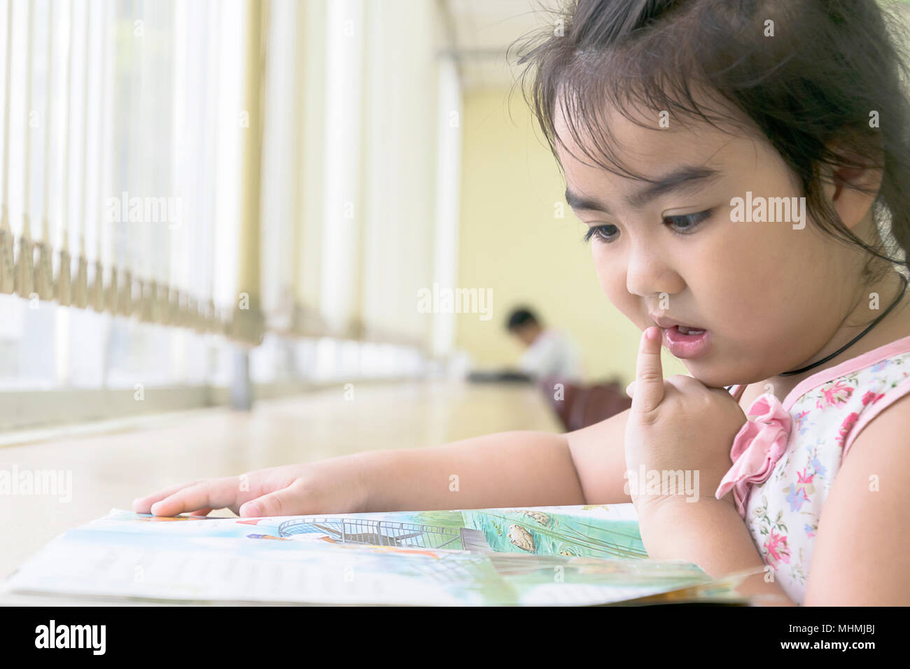 The children are reading books in the library.Reading is the best way ...