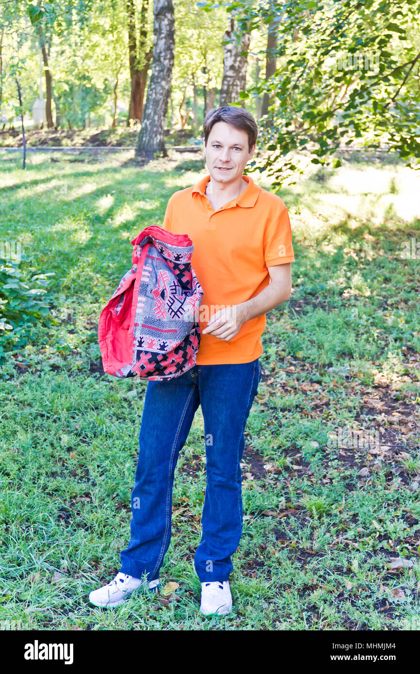 Speaking man in orange with red blanket on green background Stock Photo ...