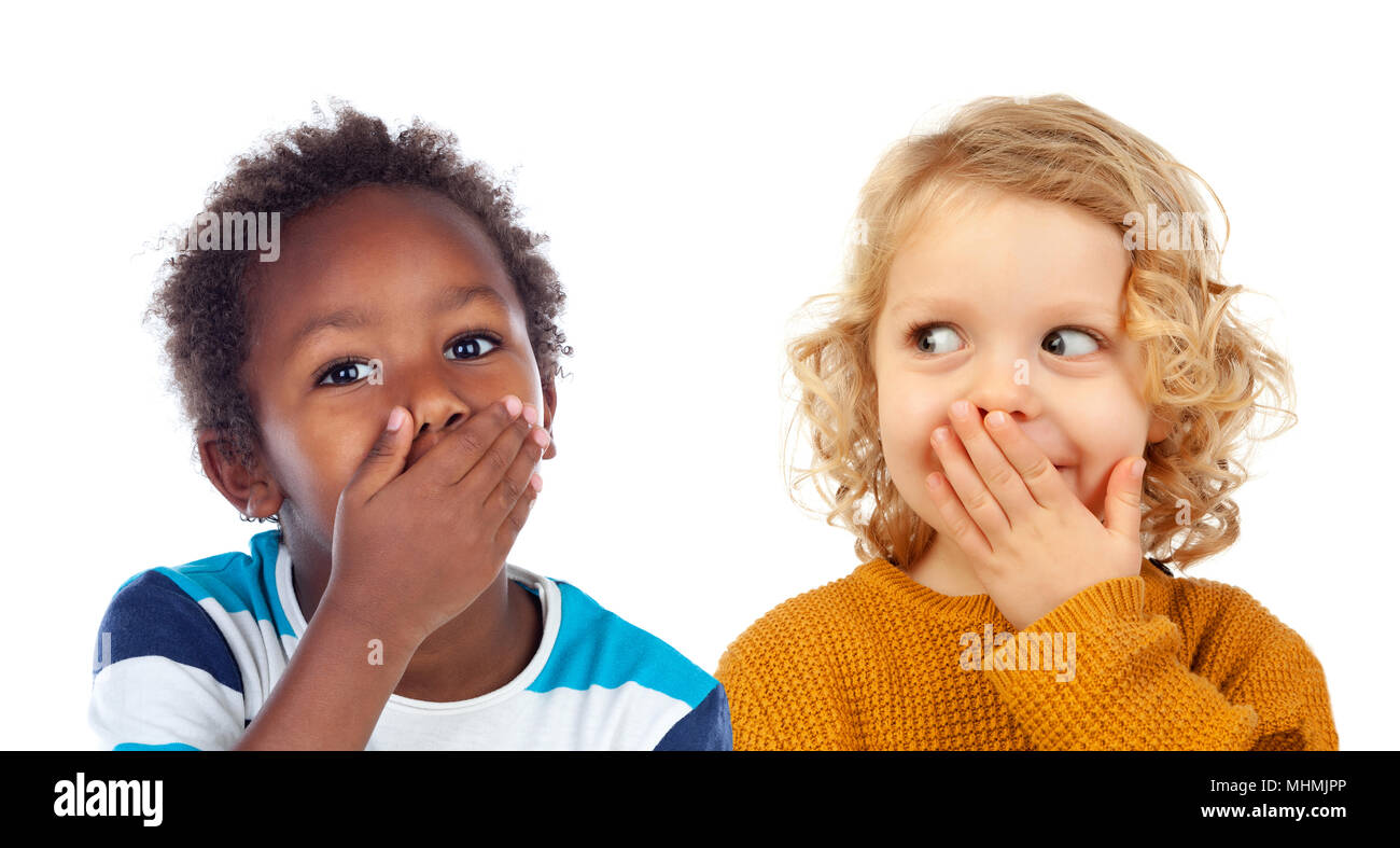 Two small children covering their mouths isolated on a white background ...