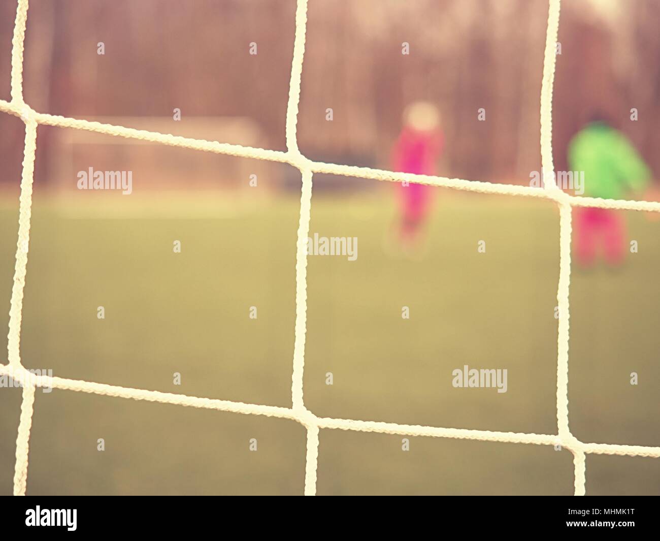 Soccer football net background over green grass and blurry stadium ...