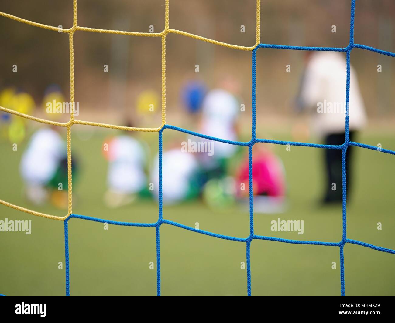 Football gate net. Soccer gate net. In blurry background stand players ...
