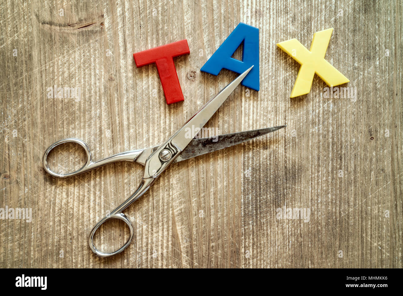 Cut of tax Concept. Scissors and the colorful plastic alphabet on ...
