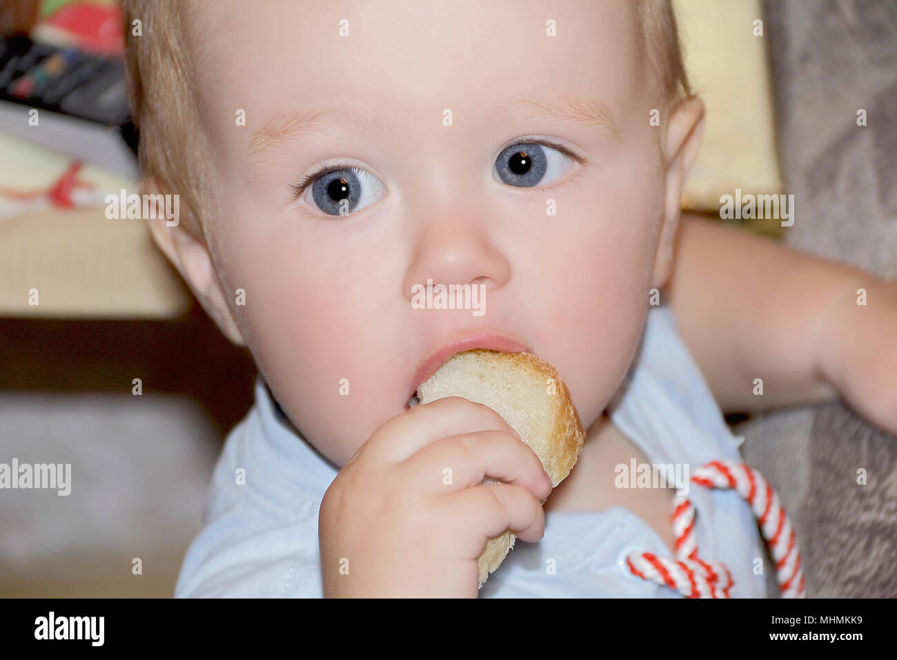 Image of cute baby boy eating bread Stock Photo - Alamy