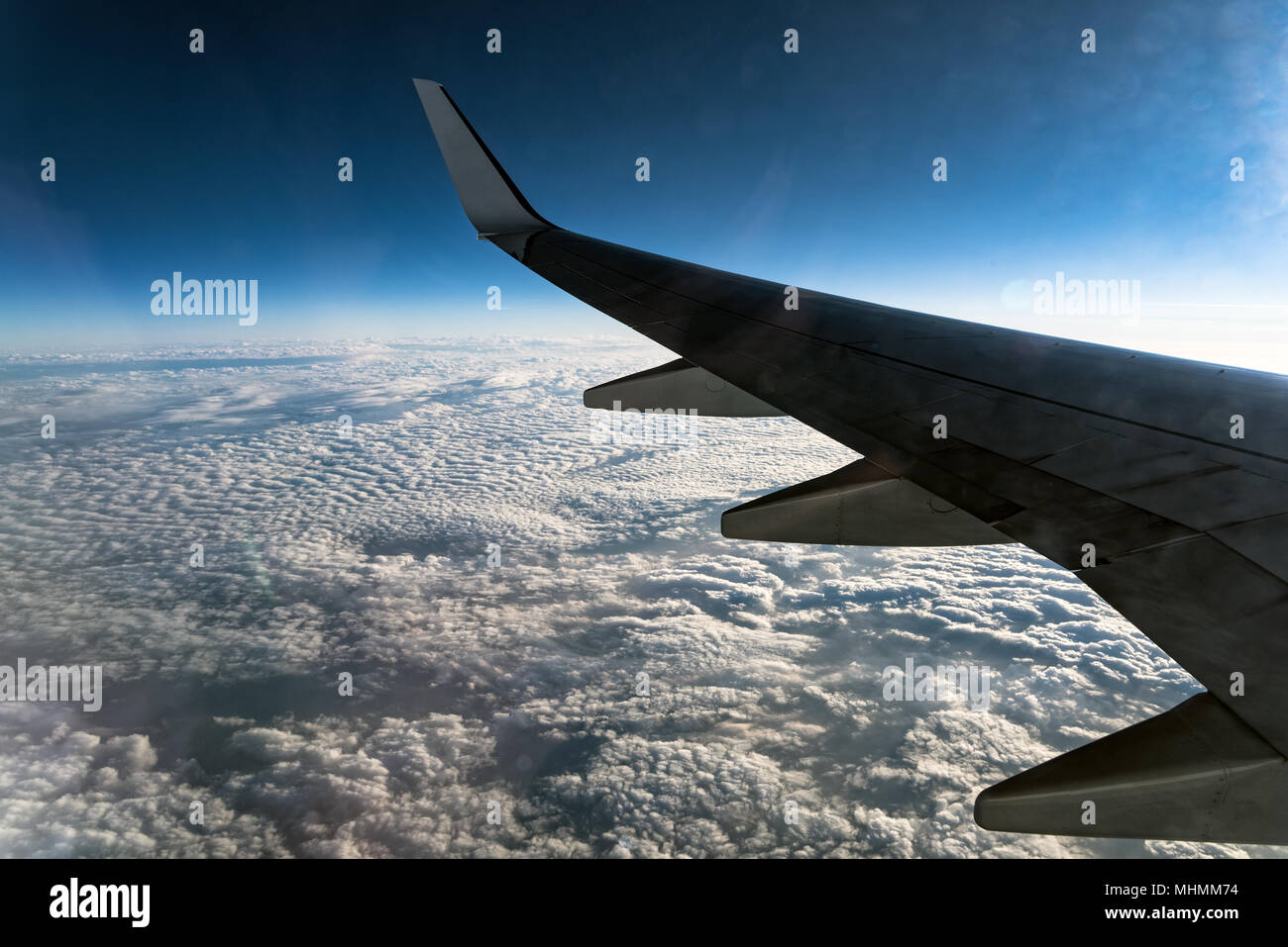 View through the window of the wing of an airplane flying above the ...