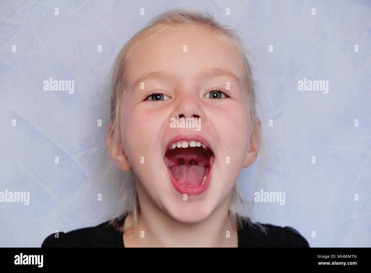 Portrait of girl with smile and open mouth Stock Photo - Alamy