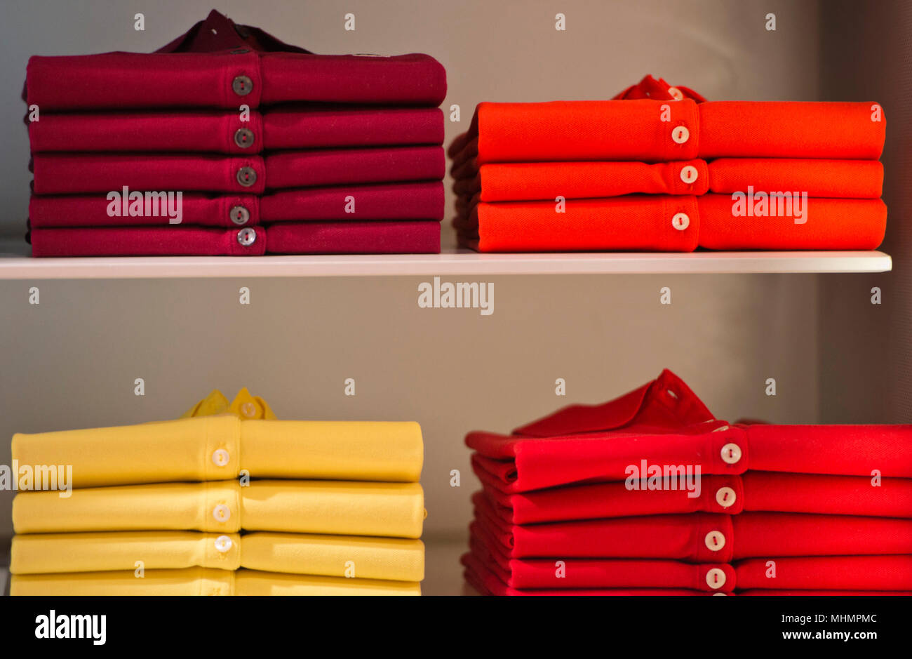 different colors polo shirt on display stand Stock Photo - Alamy