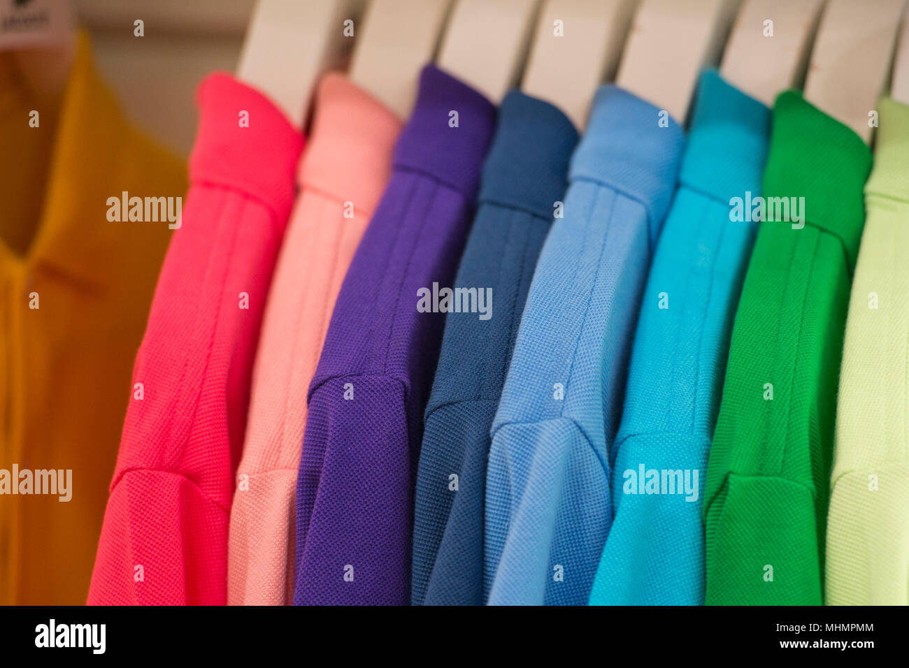 different colors polo shirt on display stand Stock Photo - Alamy