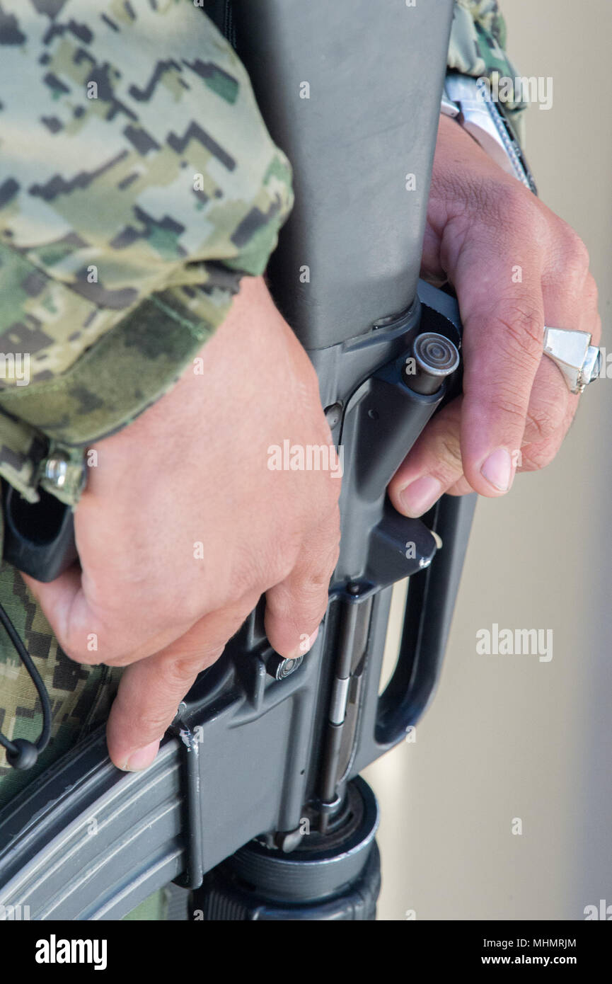 male soldier hands holding machine gun Stock Photo - Alamy