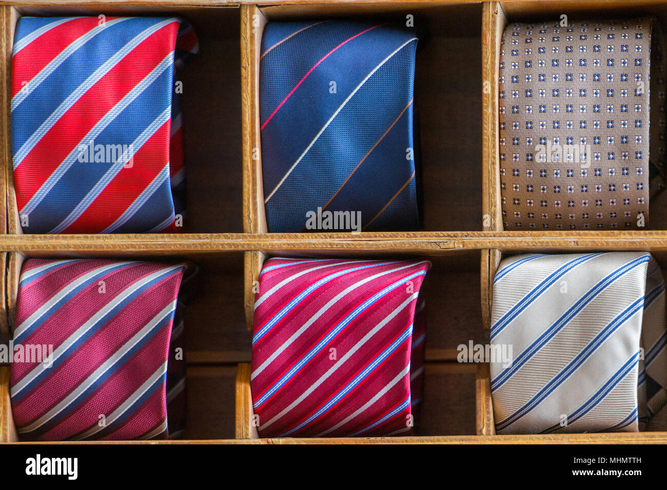 different colors silk tie on display stand Stock Photo - Alamy