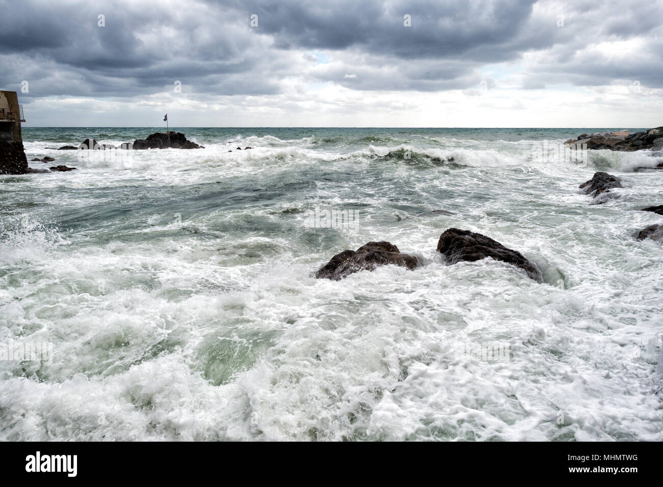 sea in tempest on rocks with splashes Stock Photo - Alamy