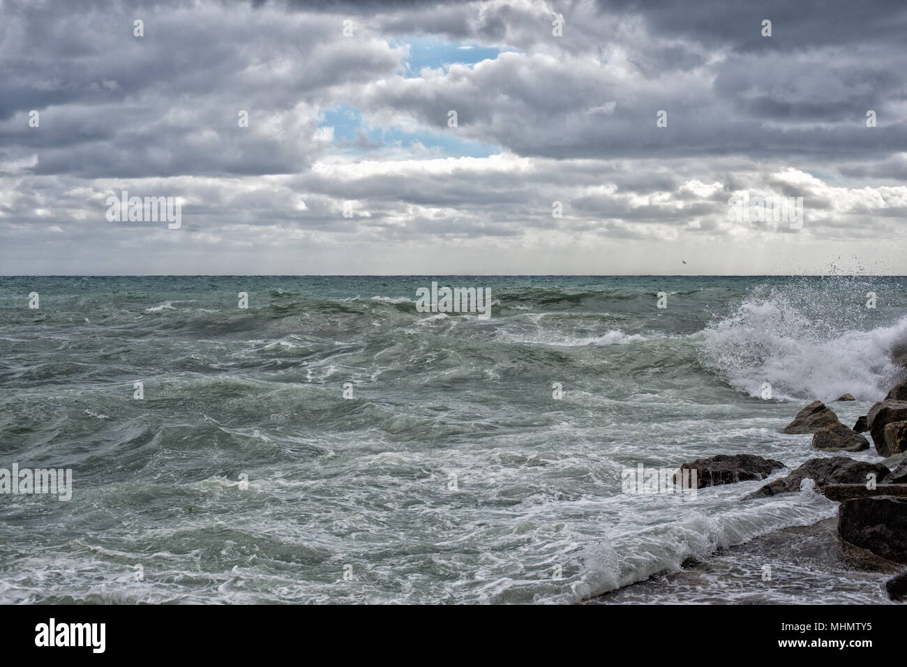 sea in tempest on rocks with splashes Stock Photo - Alamy