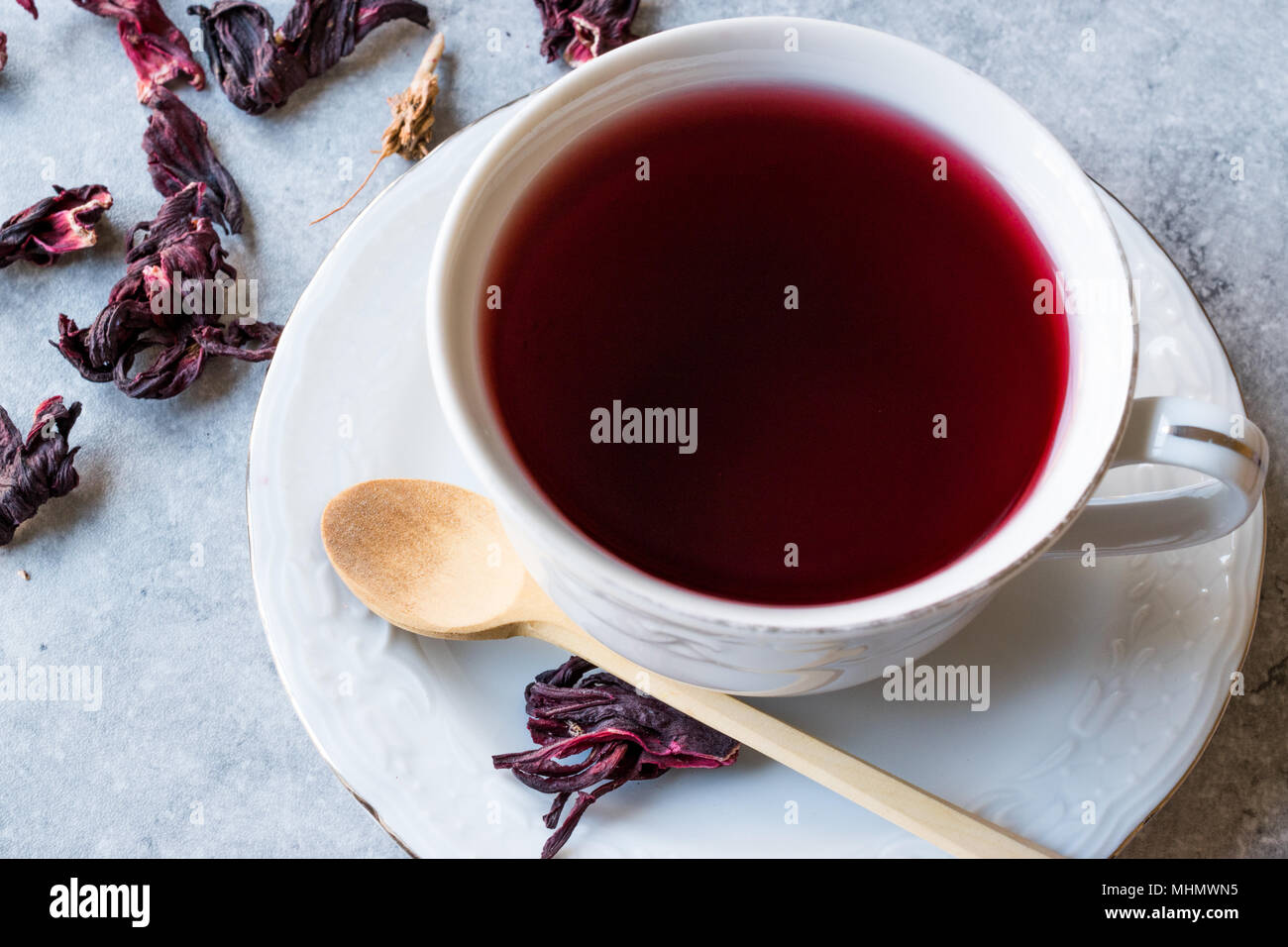 Red Hot Hibiscus Tea in White Cup with Dried Hibiscus Tea Leaves ...