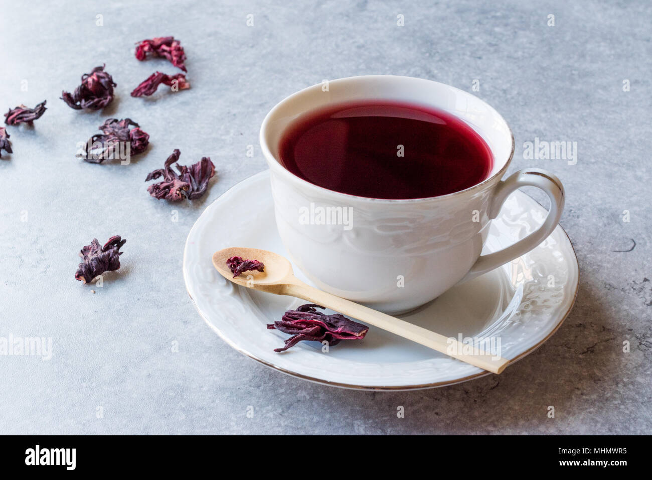 Red Hot Hibiscus Tea in White Cup with Dried Hibiscus Tea Leaves ...