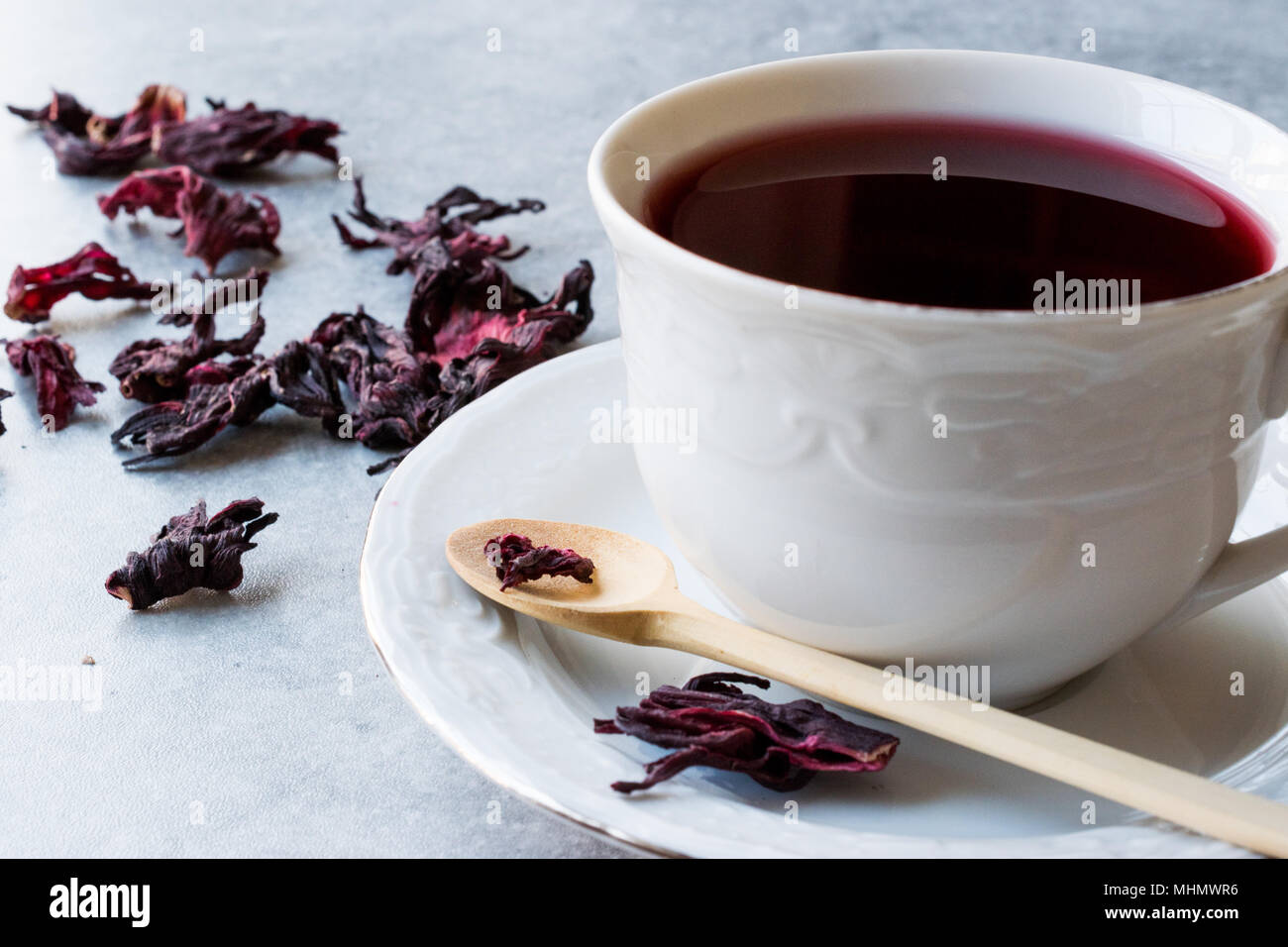 Red Hot Hibiscus Tea in White Cup with Dried Hibiscus Tea Leaves ...