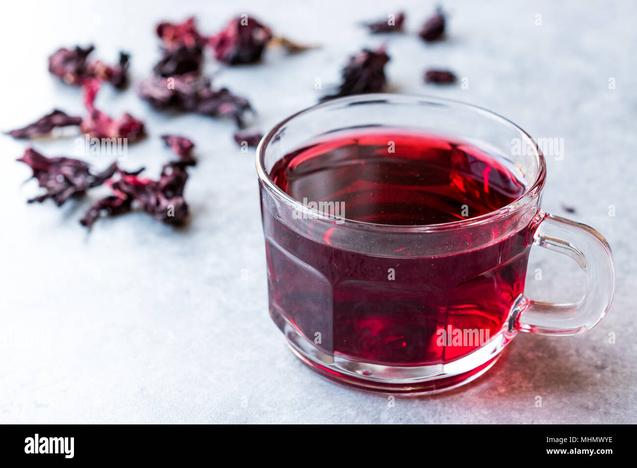 Red Hot Hibiscus Tea in a Glass Mug with Dry Hibiscus Tea Leaves ...