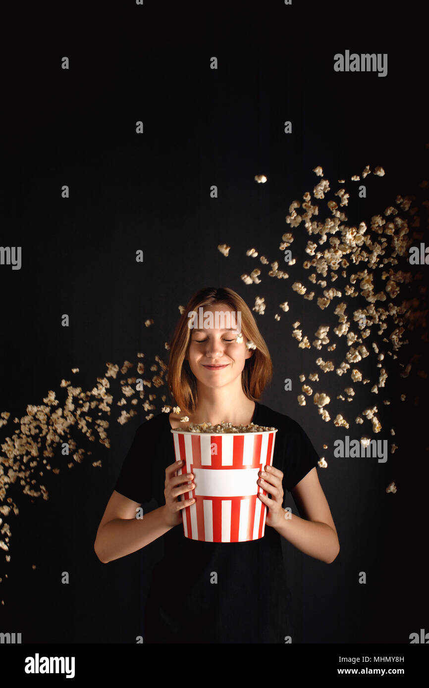 woman with spilling popcorn Stock Photo - Alamy