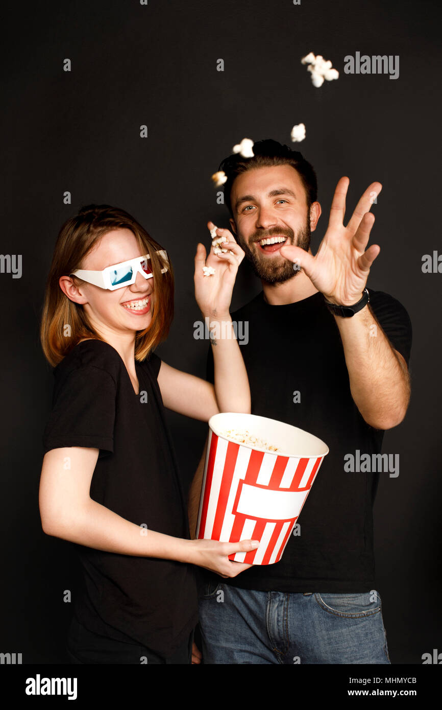 couple throwing popcorn at camera Stock Photo - Alamy