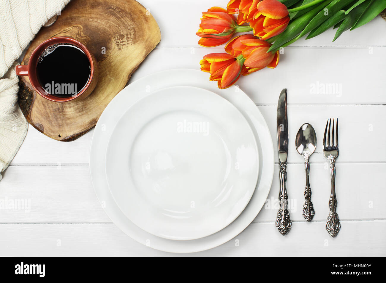 Overhead shot an empty dinner plate with coffee and a bouquet of ...