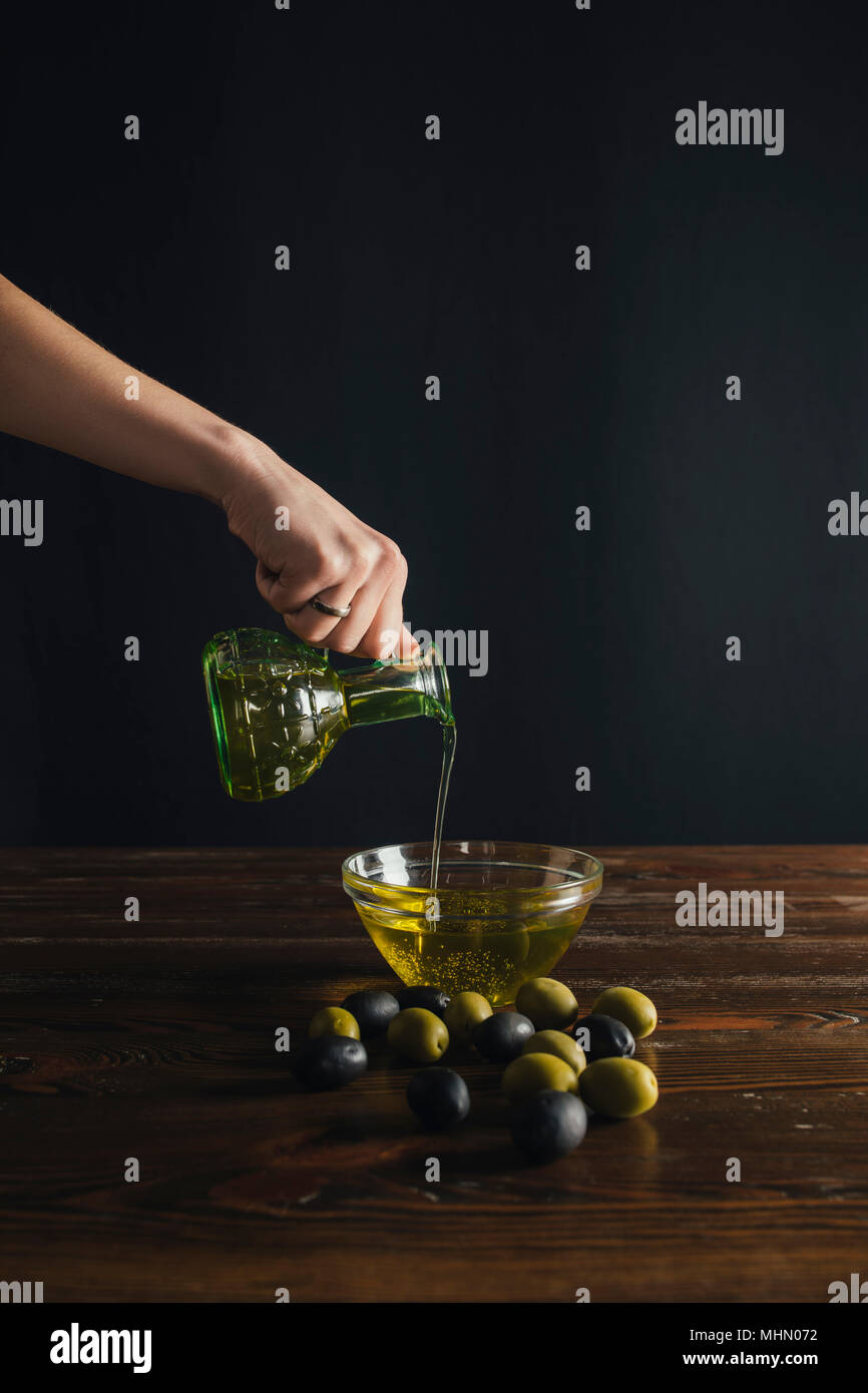 Female hand pouring oil hi-res stock photography and images - Alamy