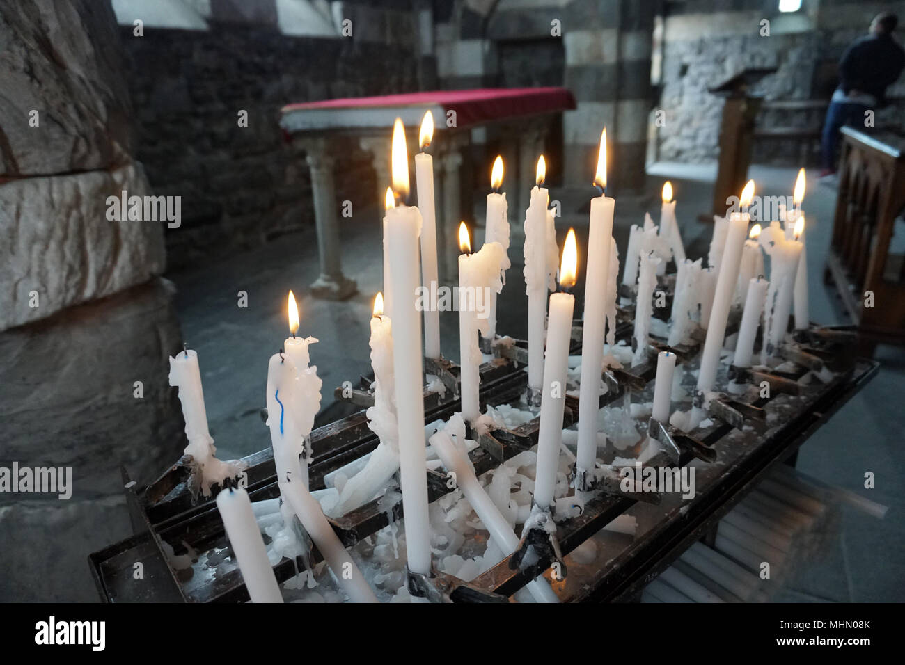 church candles weaving flames inside old medieval church Stock Photo ...