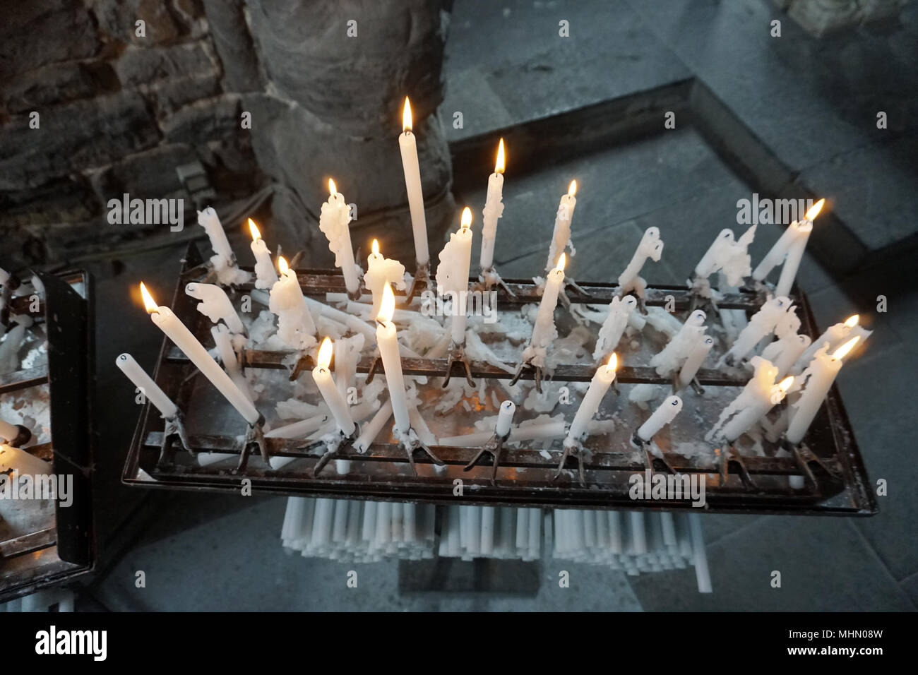 church candles weaving flames inside old medieval church Stock Photo ...