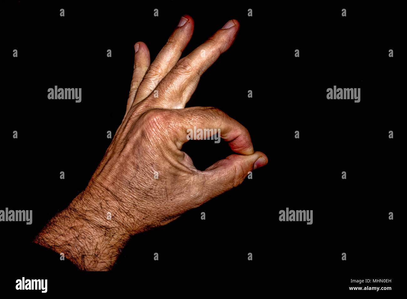 old man left hand isolated on black ok sign Stock Photo - Alamy