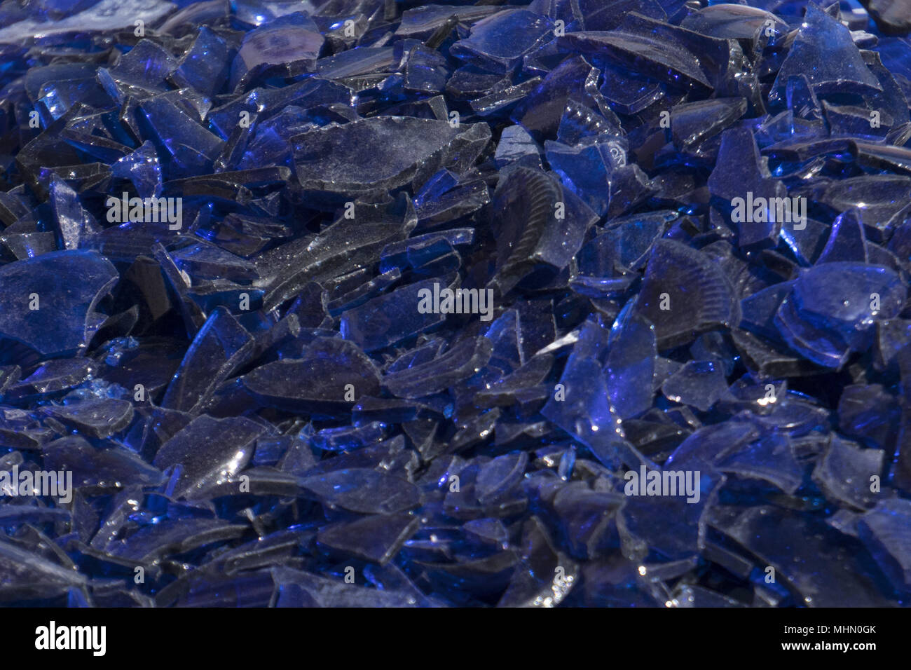 Broken glass many color pieces detail Stock Photo - Alamy