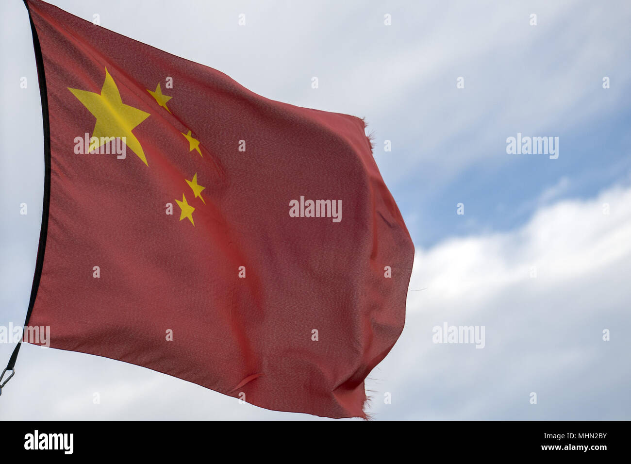 waving china flag red background and yellow stars Stock Photo - Alamy