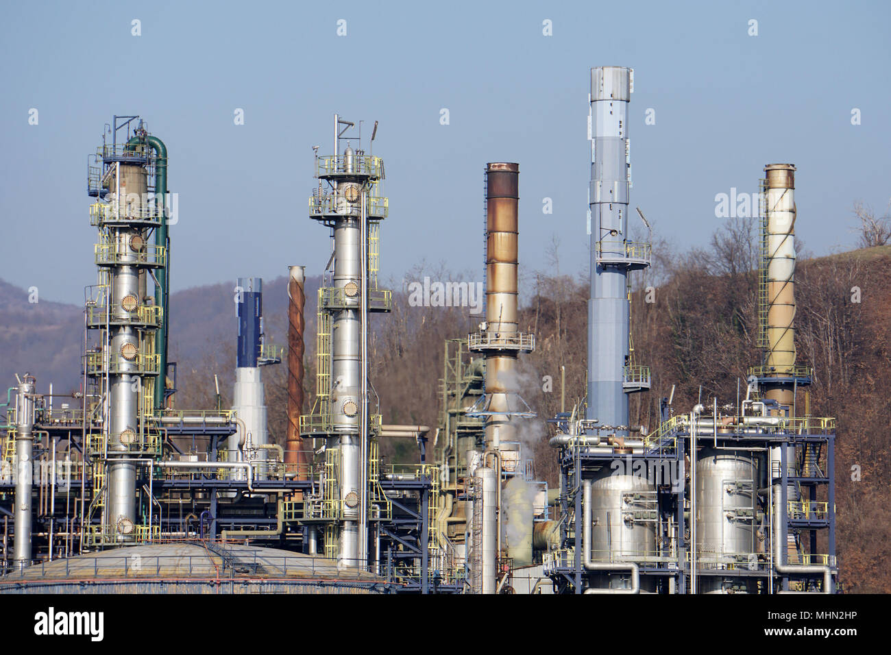 oil refinery on blue sky cloudy background Stock Photo - Alamy
