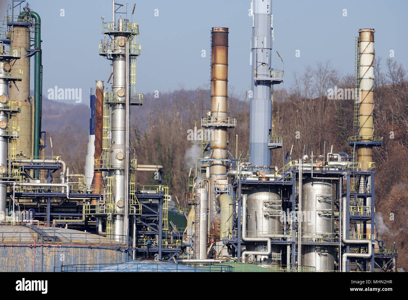 oil refinery on blue sky cloudy background Stock Photo - Alamy