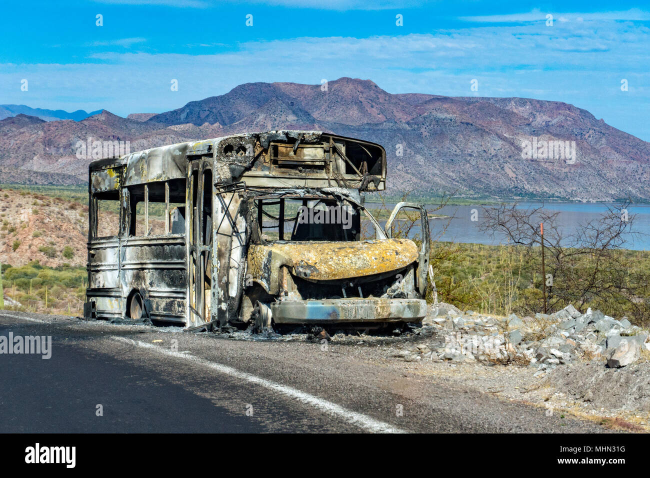 burned abandoned rv school bus on california road Stock Photo - Alamy