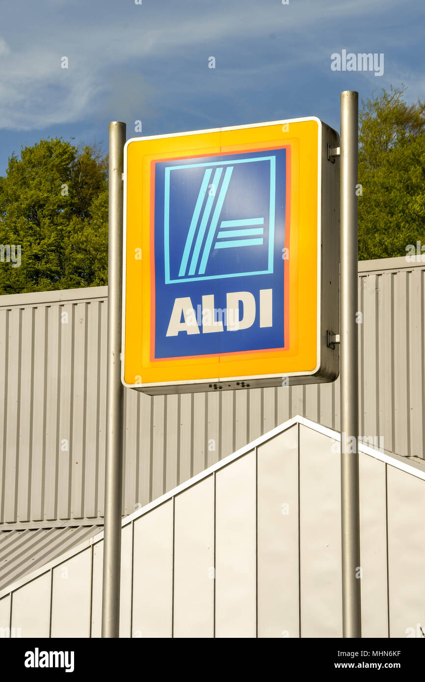 Large sign above the entrance to an Aldi supermarket in a retail park ...