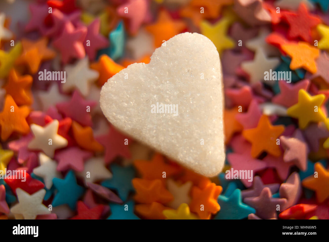 colorful sugar stars coating with white shugar heart on it Stock Photo ...