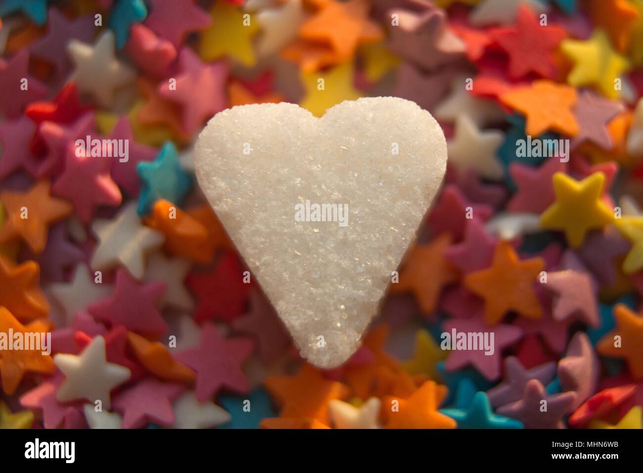 colorful sugar stars coating with white shugar heart on it Stock Photo ...