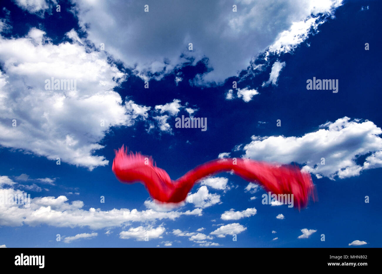 Blue sky with white fluffy clouds and red scarf blowing away Stock ...