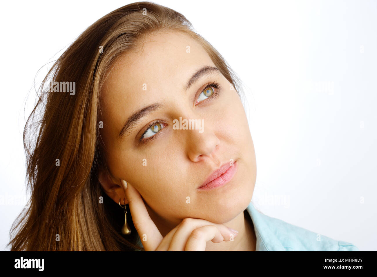 Portrait of young woman thinking about something Stock Photo - Alamy