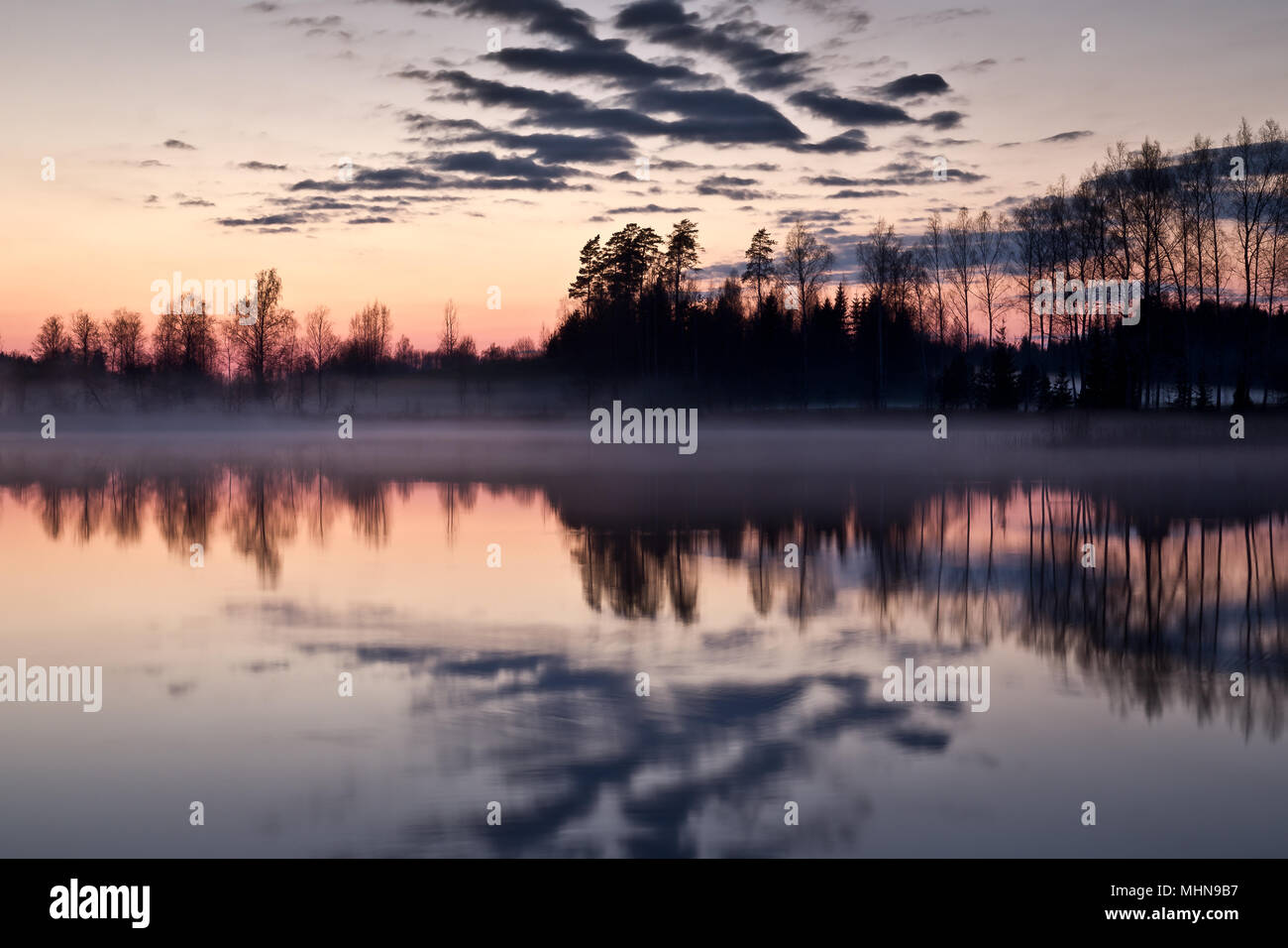 Misty sunset by the lake, Latvia Stock Photo - Alamy