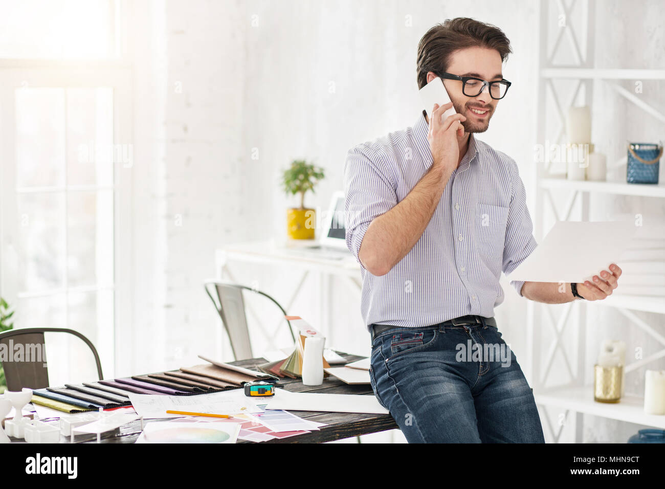 Exuberant manager talking on the phone Stock Photo - Alamy