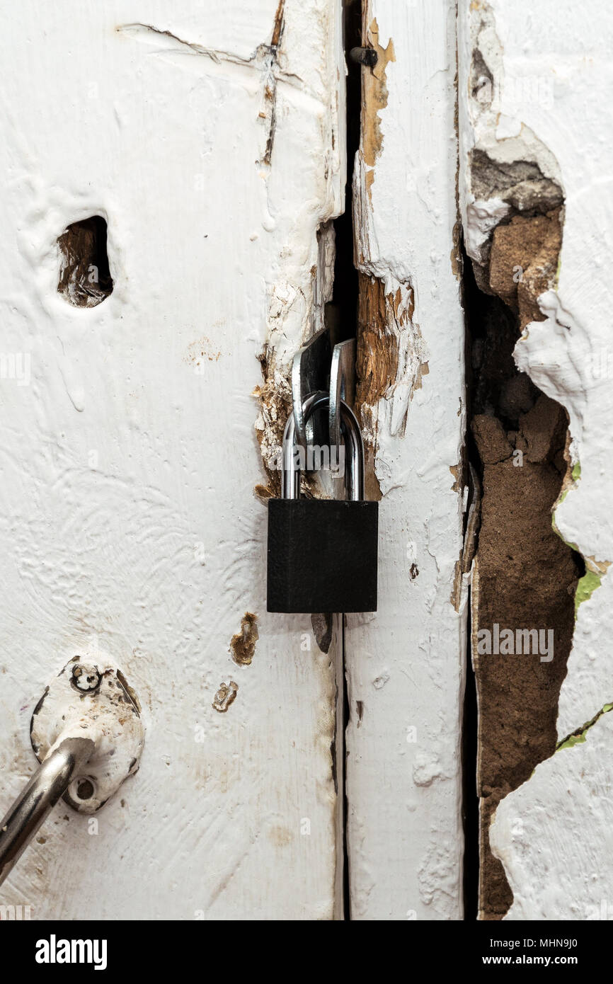 Small closed lock on an old door Stock Photo - Alamy